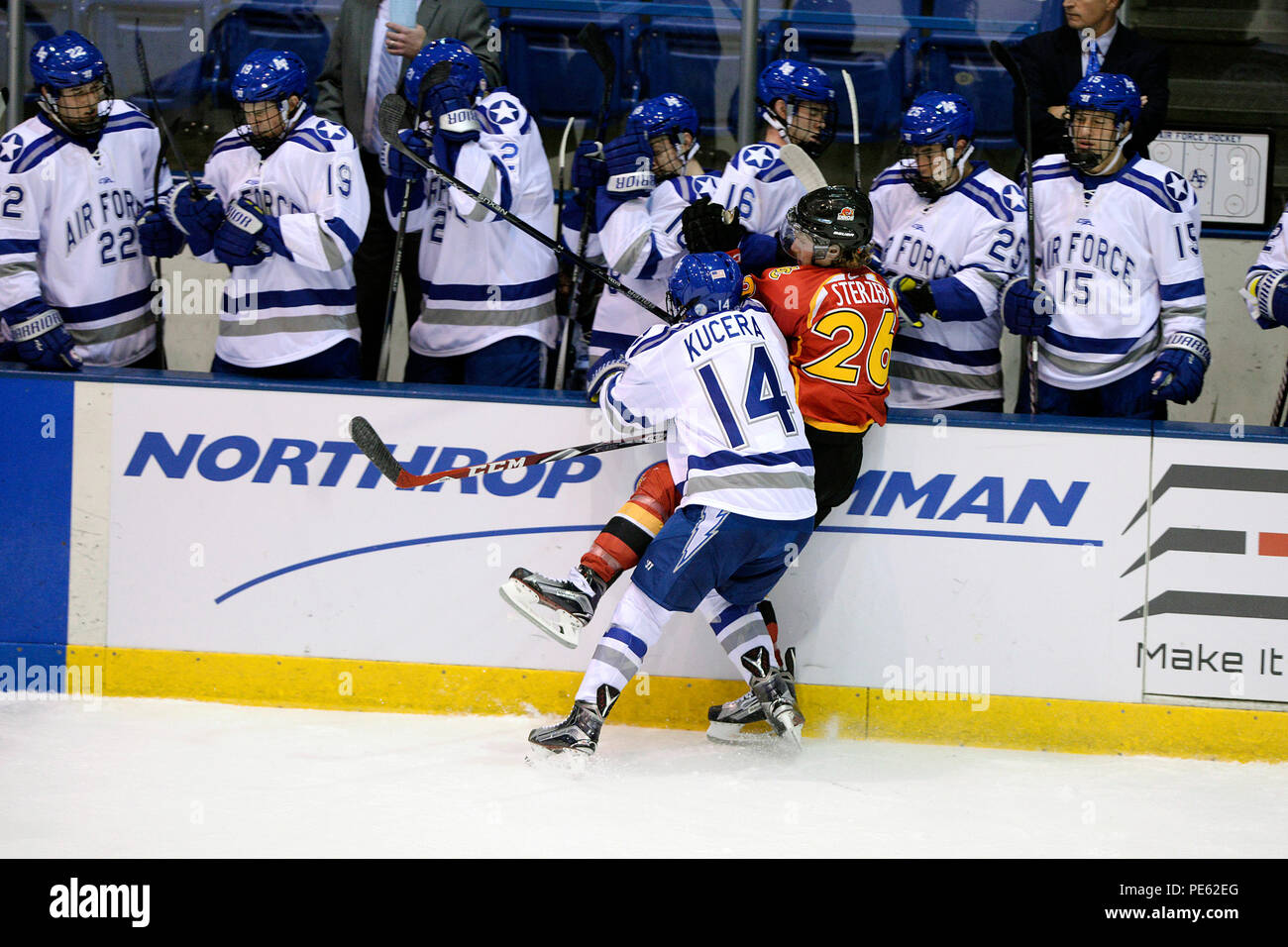 Ben Kucera, a sophomore, checks Calgary's Aspen Sterzer in front of the ...