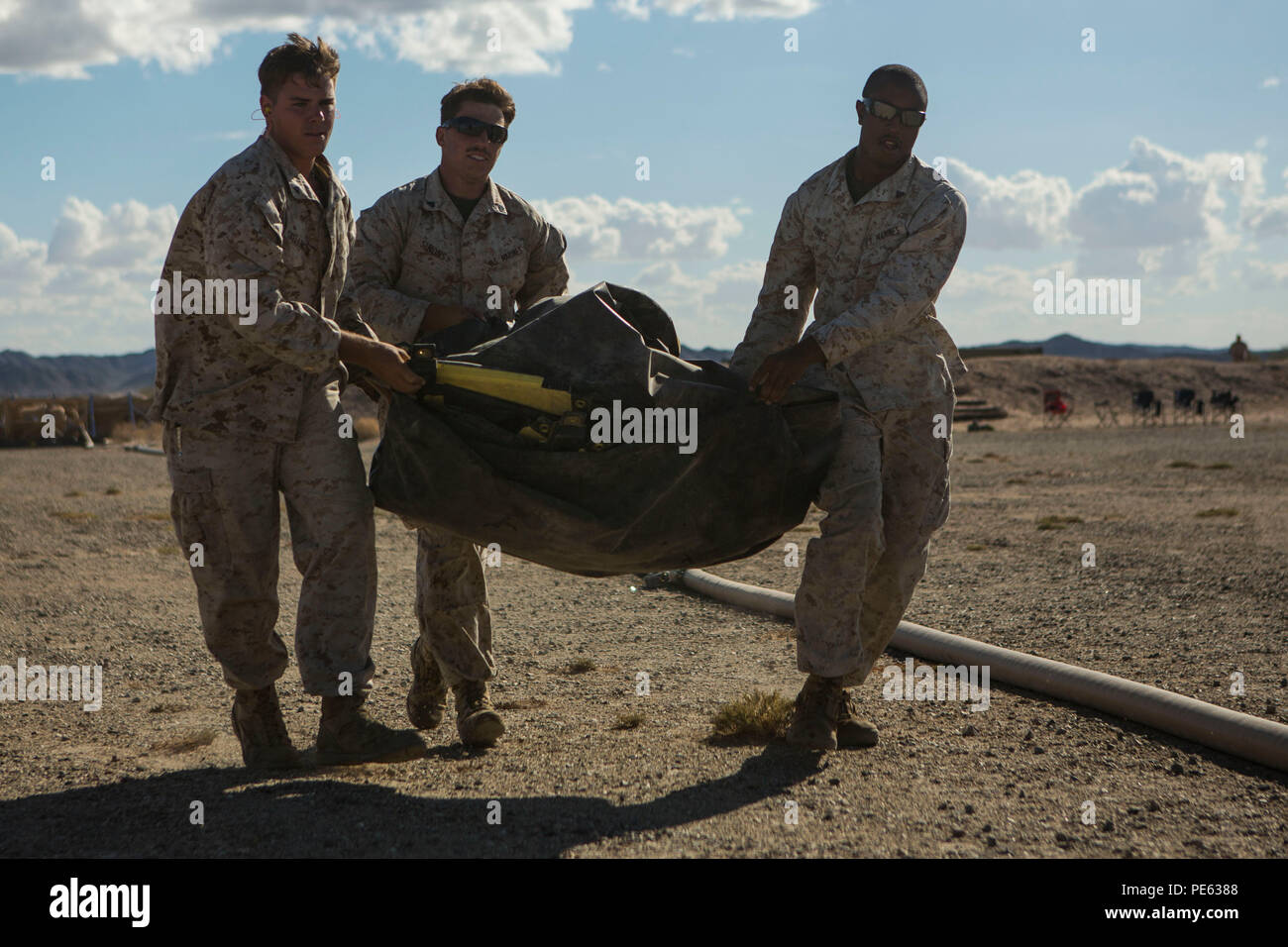 U.S. Marines with aviation ground support carry a rigid-lock quickberm ...