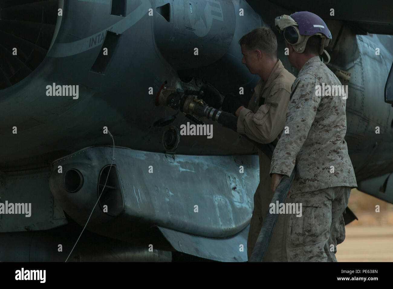 U.S. Marines with aviation ground support fuel the AV-8B Harrier during ...