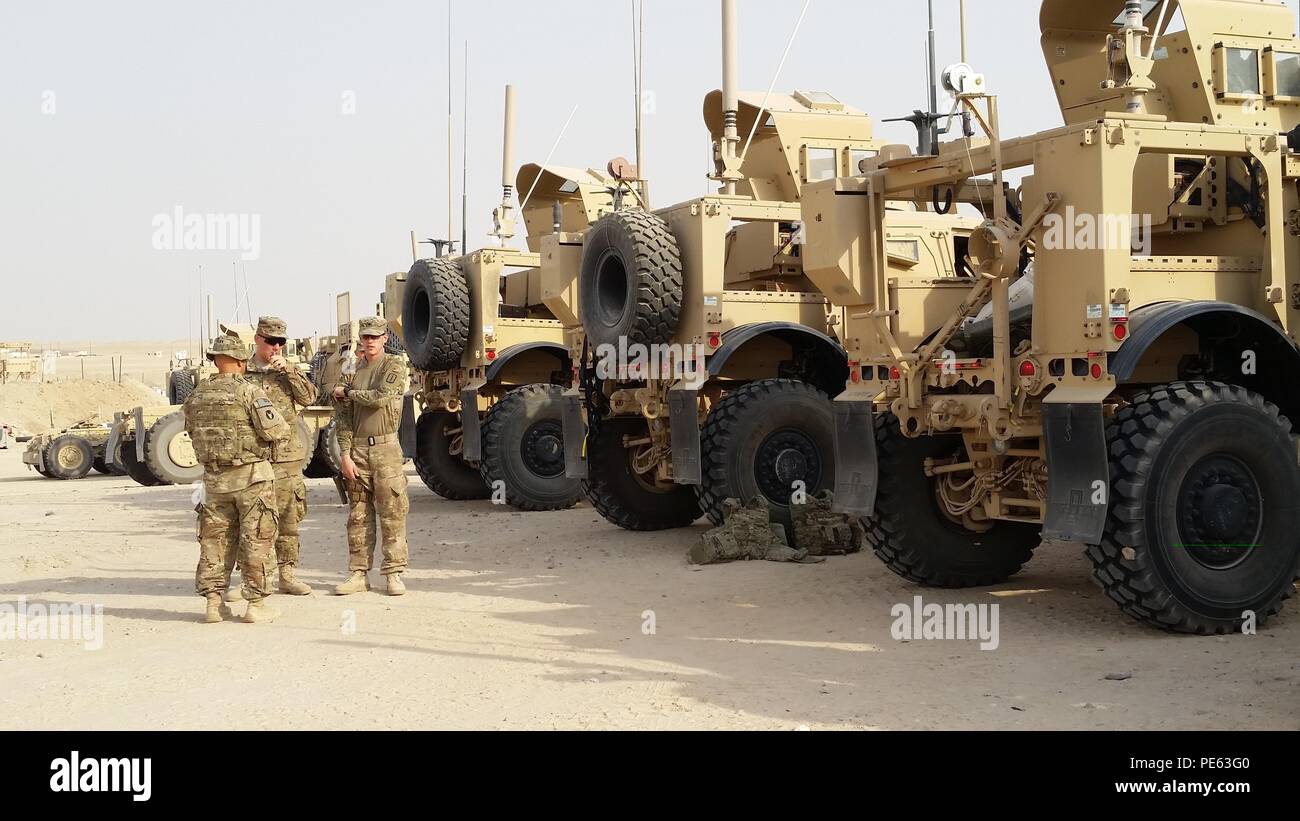Soldiers talk over the upcoming mission before loading the vehicles ...
