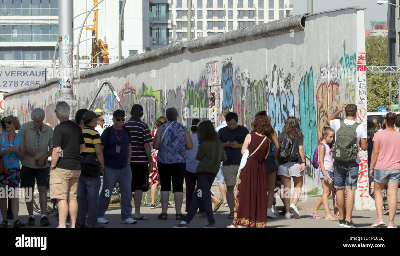 Berlin, Germany. 13th Aug, 2018. People walk along the remains of the ...