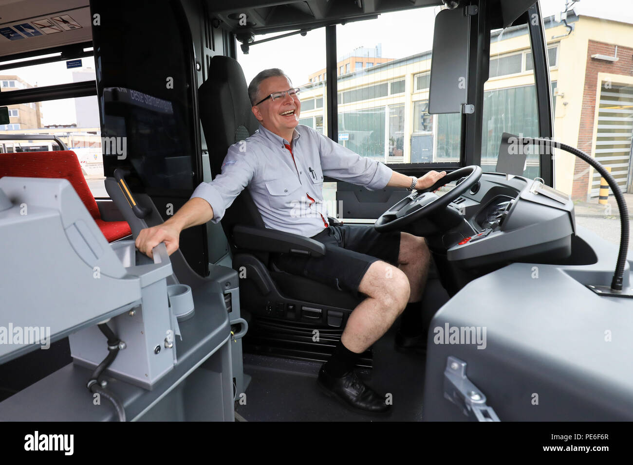 Hamburg, Germany. 13th Aug, 2018. Bus driver Andreas Hinze sits with ...