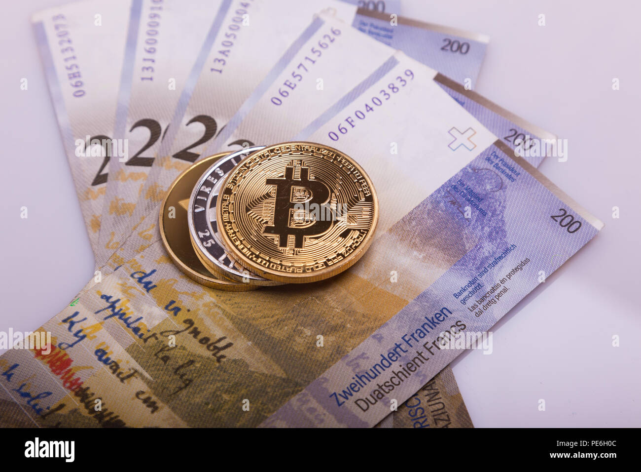 Bitcoin btc crypto currency coin over swiss francs bank notes Stock ...