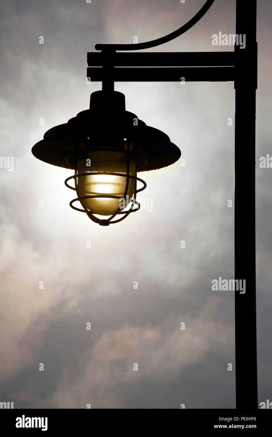 Dramatic street light in the morning with cloudy background Stock Photo ...
