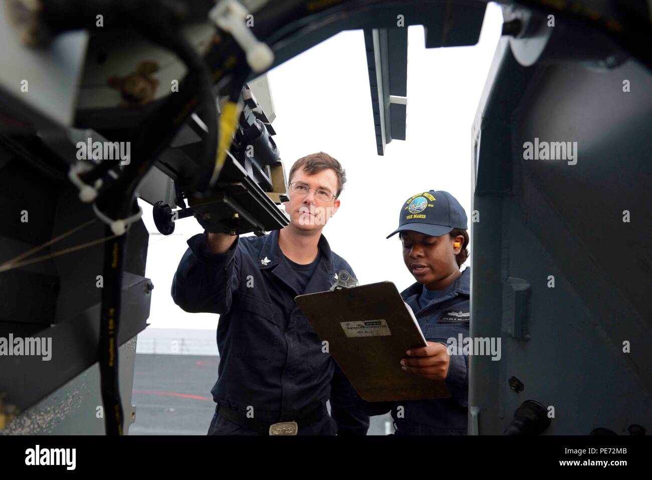 151011-N-VY489-041 MEDITERRANEAN SEA (Oct. 11, 2015) Petty Officer 2nd Class Kevin Rokes, left ...