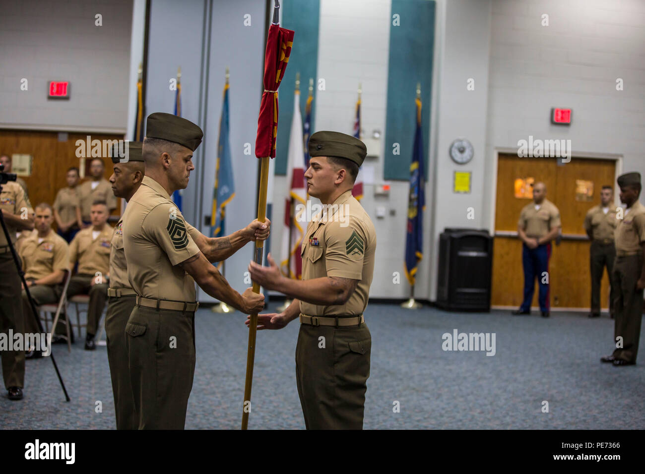 U.S. Marine Corps 1st Sgt. Jose Guerreiro, first sergeant, hands the ...
