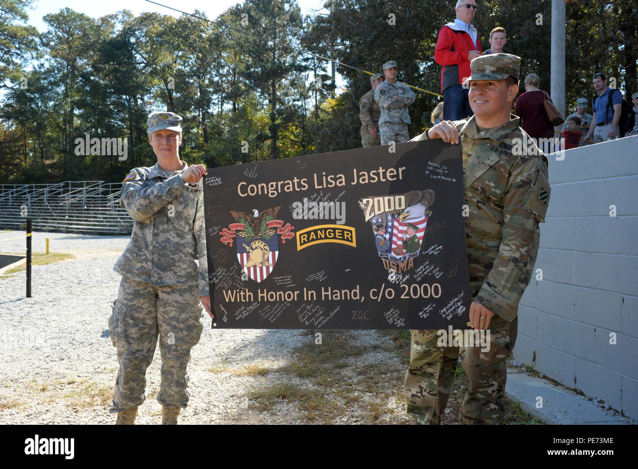 Friends of U.S. Army Maj. Lisa Jaster hold a sign of support during ...
