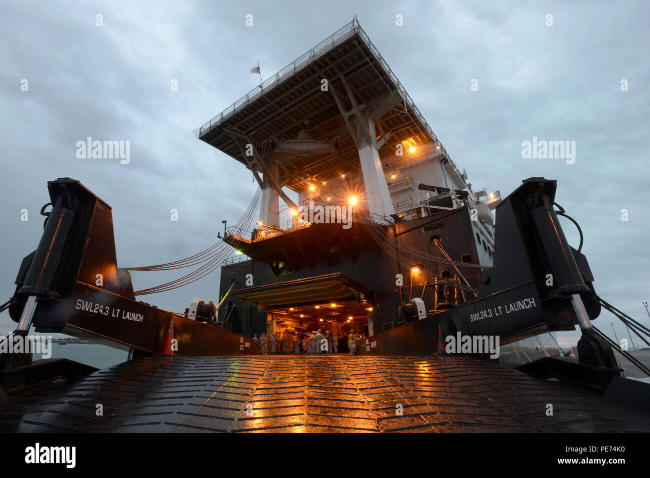U.S. Marines unload vehicles and equipment from the U.S. Naval Ship SGT ...