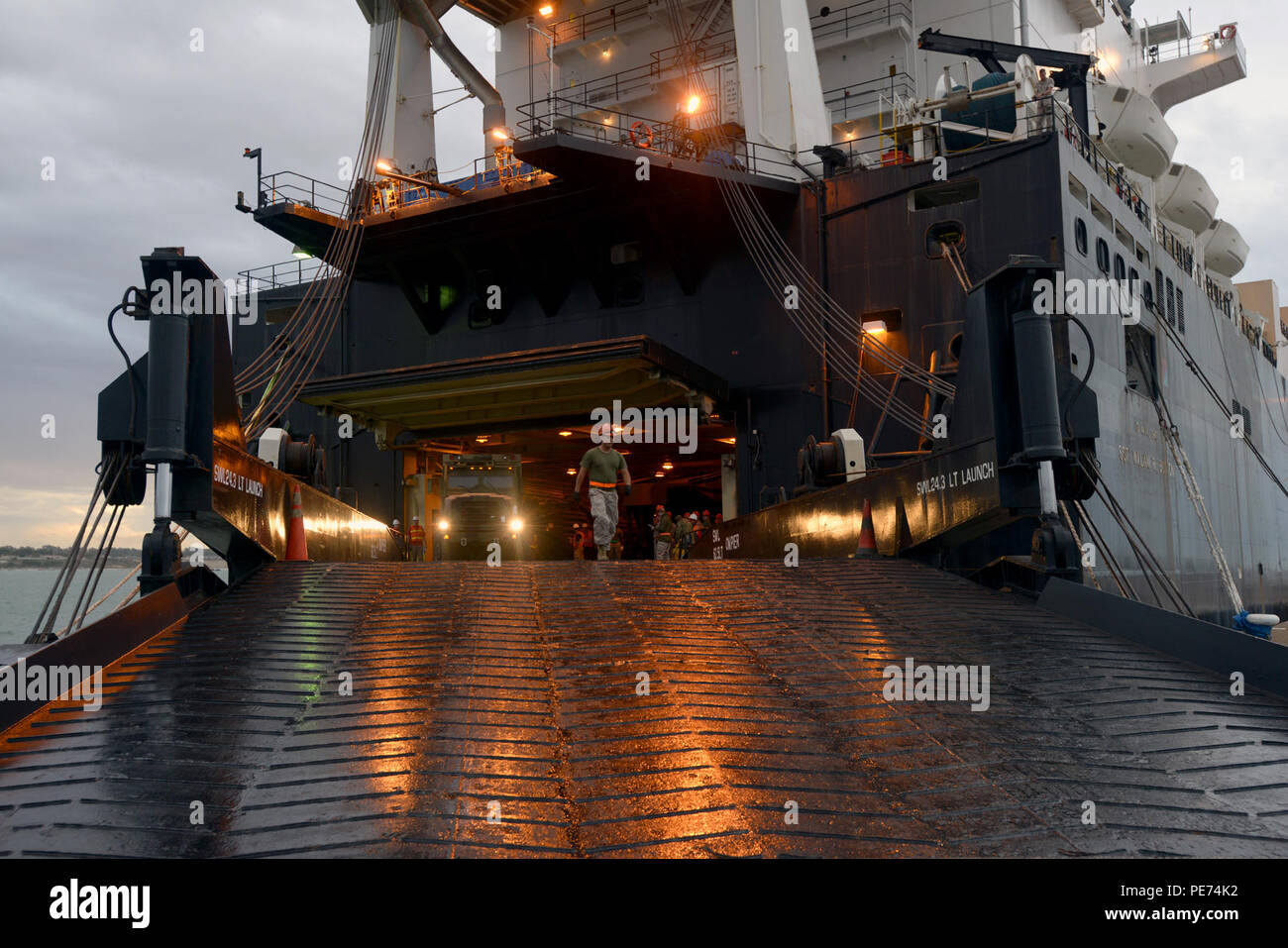 U.S. Marines unload vehicles and equipment from the U.S. Naval Ship SGT ...