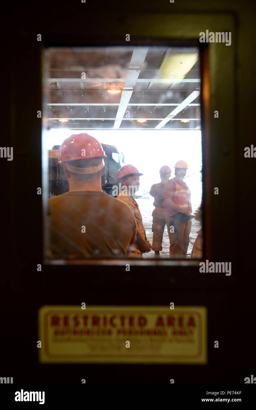 U.S. Marines unload vehicles and equipment from the U.S. Naval Ship Sgt ...