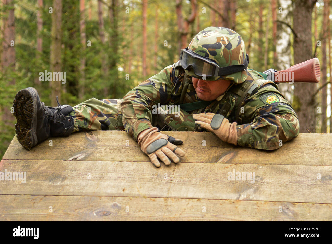A Bulgarian soldier gets over an obstacle at the Tactical Shoot lane ...