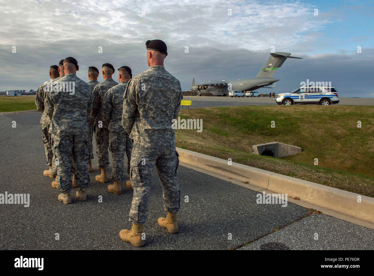 An Army Carry Team stands in place during a a dignified transfer of ...