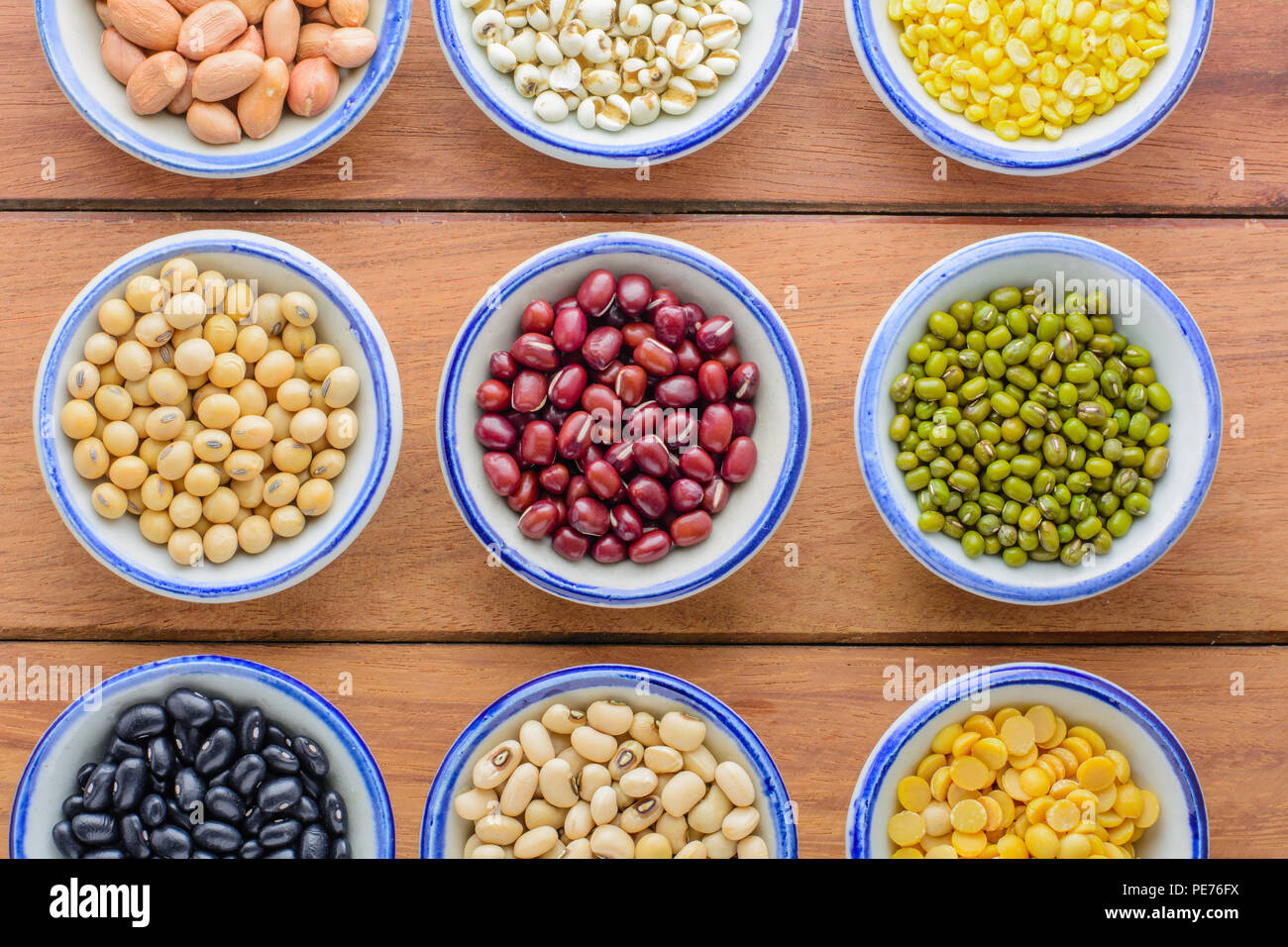 Various kinds of beans,different kinds of beans in bowl on wooden table ...