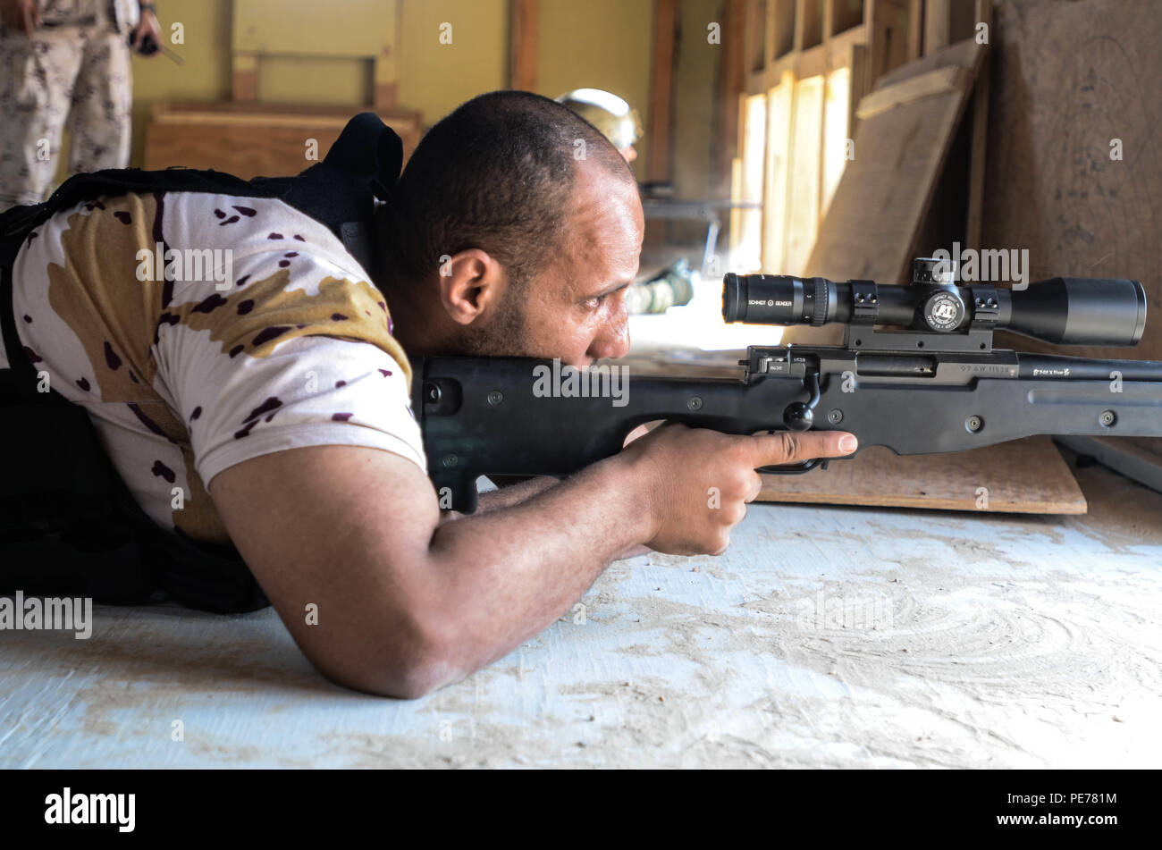 A sniper with Kuwait’s Amiri Guard fires his rifle during an urban ...