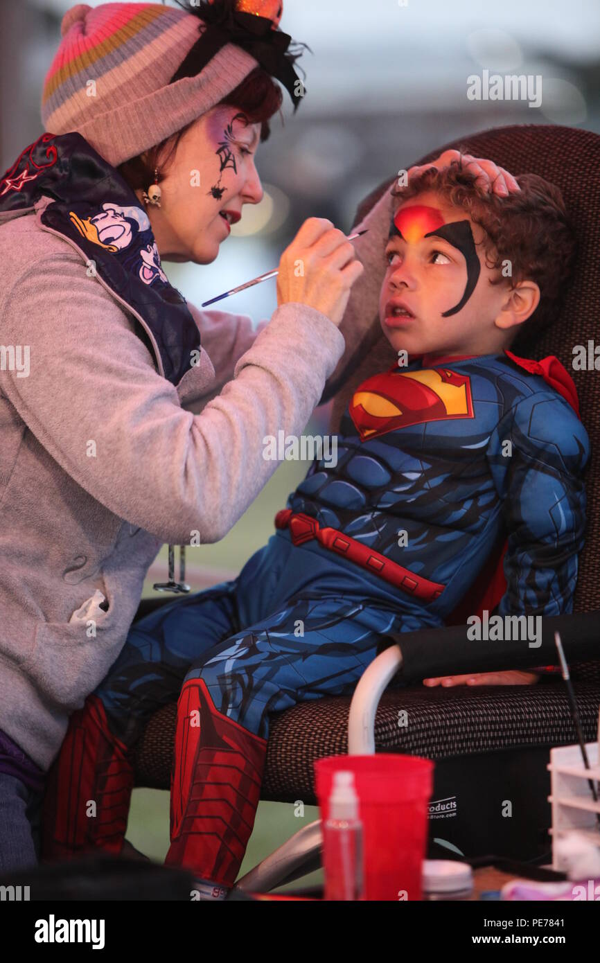 Robin Ware paints the face of 4-year-old Cameron during the Trunk-or ...