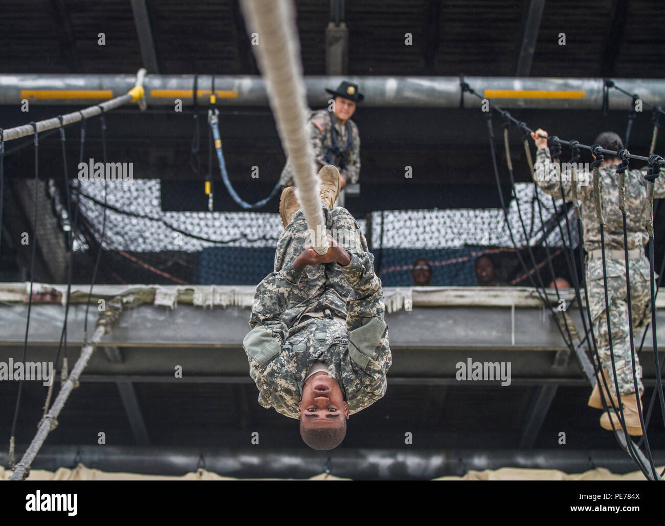 After losing his balance on a rope bridge obstacle, a Soldier in Basic ...