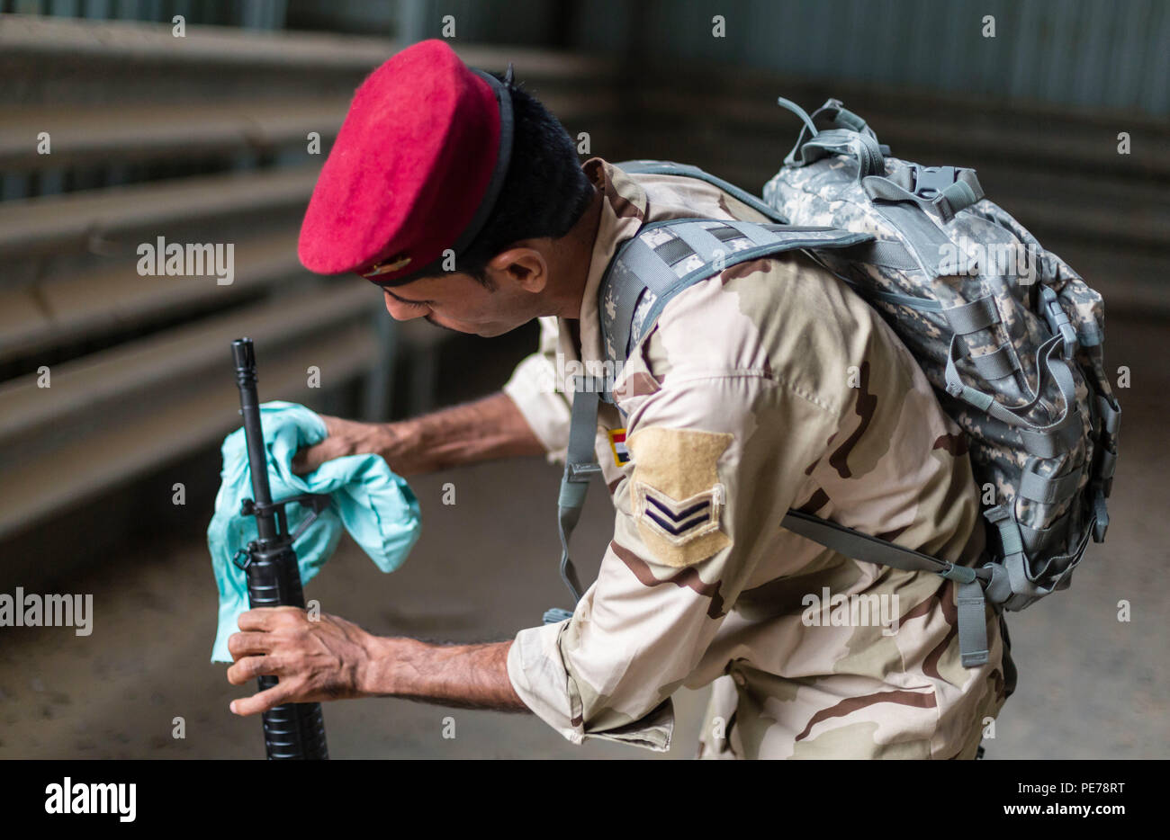 An Iraqi soldier assigned to the 71st Iraqi Army Brigade cleans oil off ...