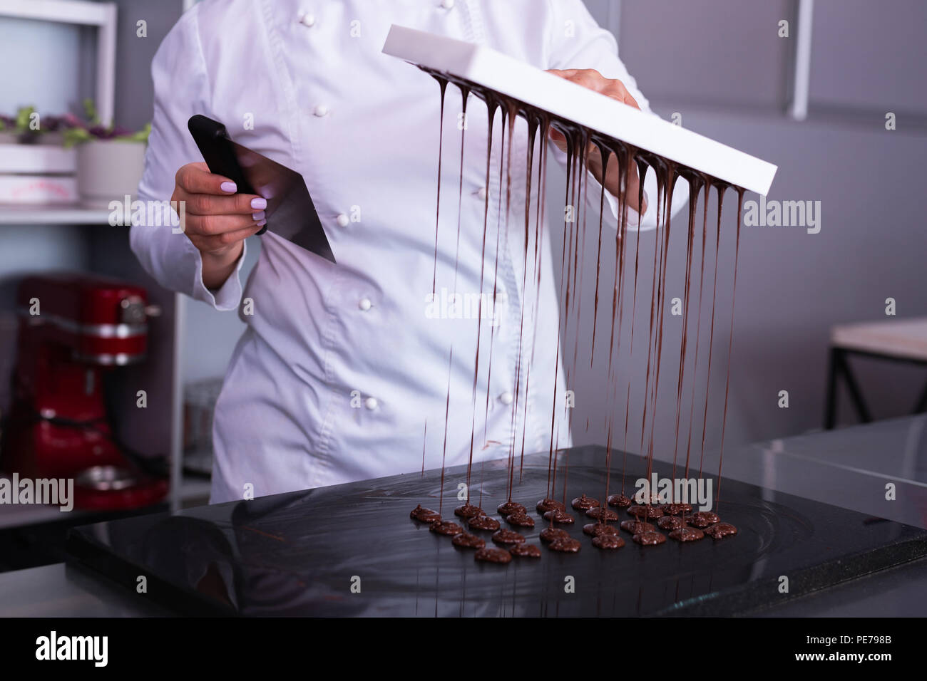 Professional chocolatier making nice little chocolate sweets Stock ...