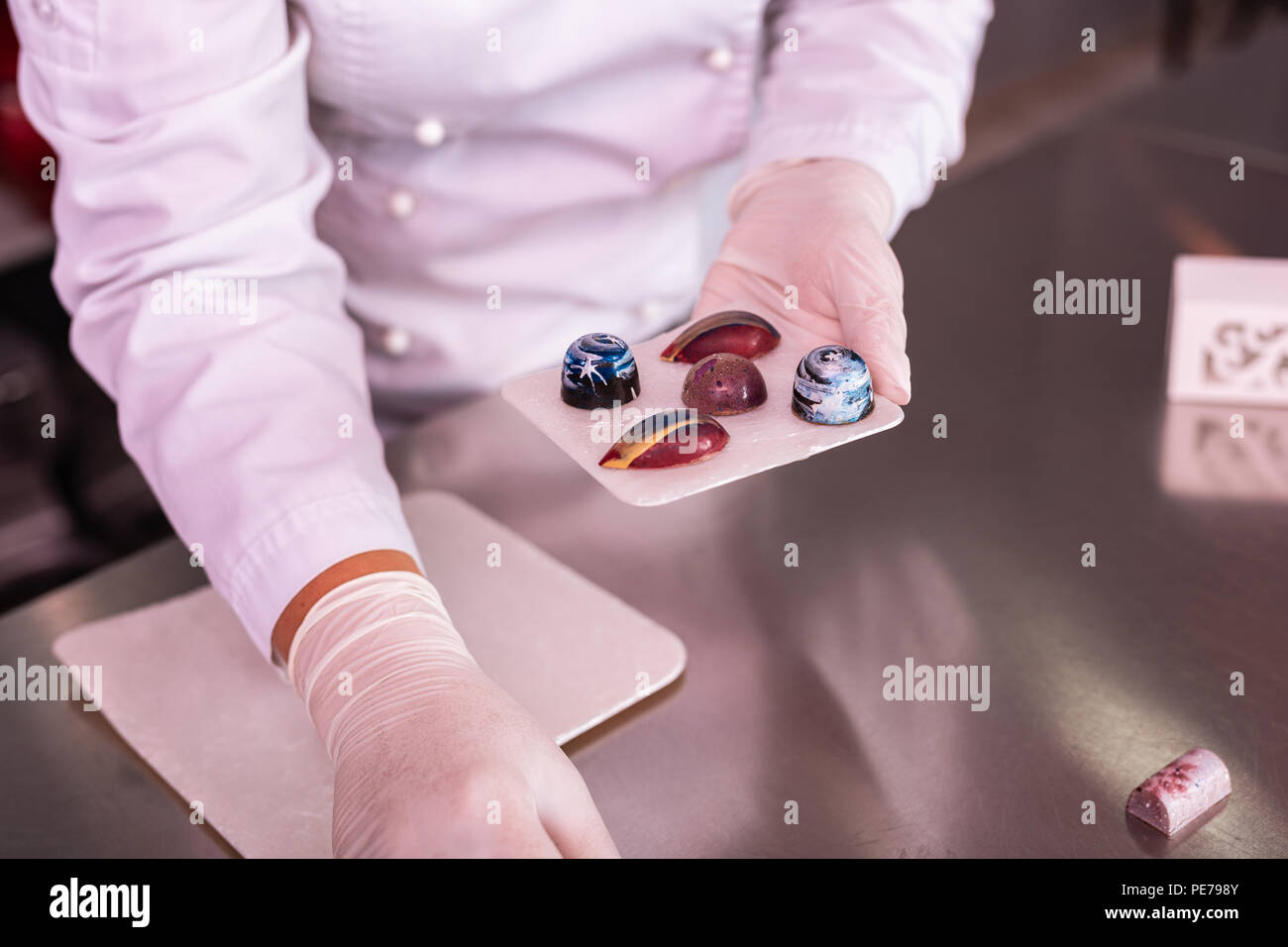 Professional chocolatier holding her perfect chocolate sweets Stock ...