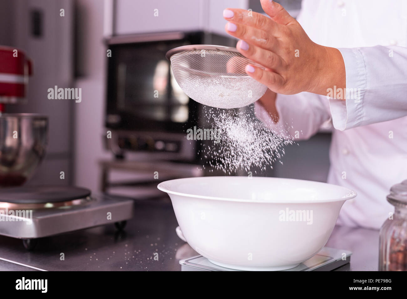 Chef with white nails sieving flour while cooking nice big pie Stock ...