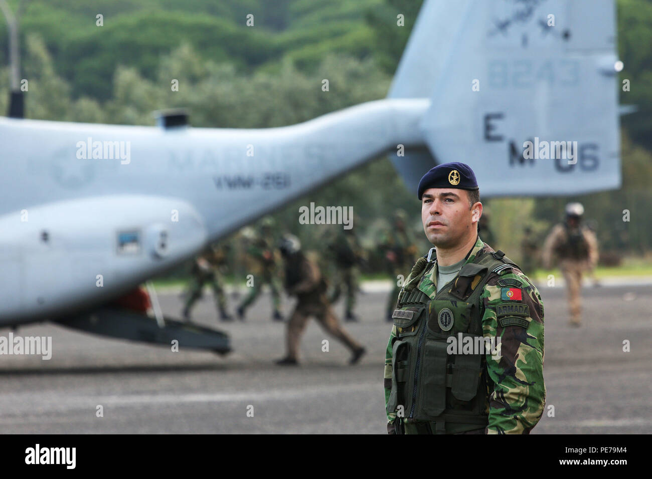 Portuguese Marine corporal L. Pedro looks on as his counterparts load ...