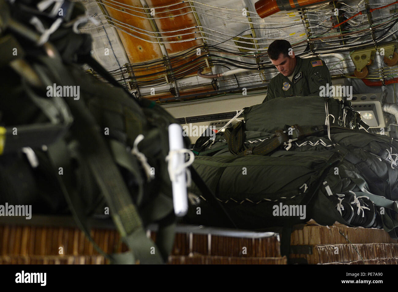 Staff Sgt. Eric Hachey, 8th Airlift Squadron loadmaster, checks the ...