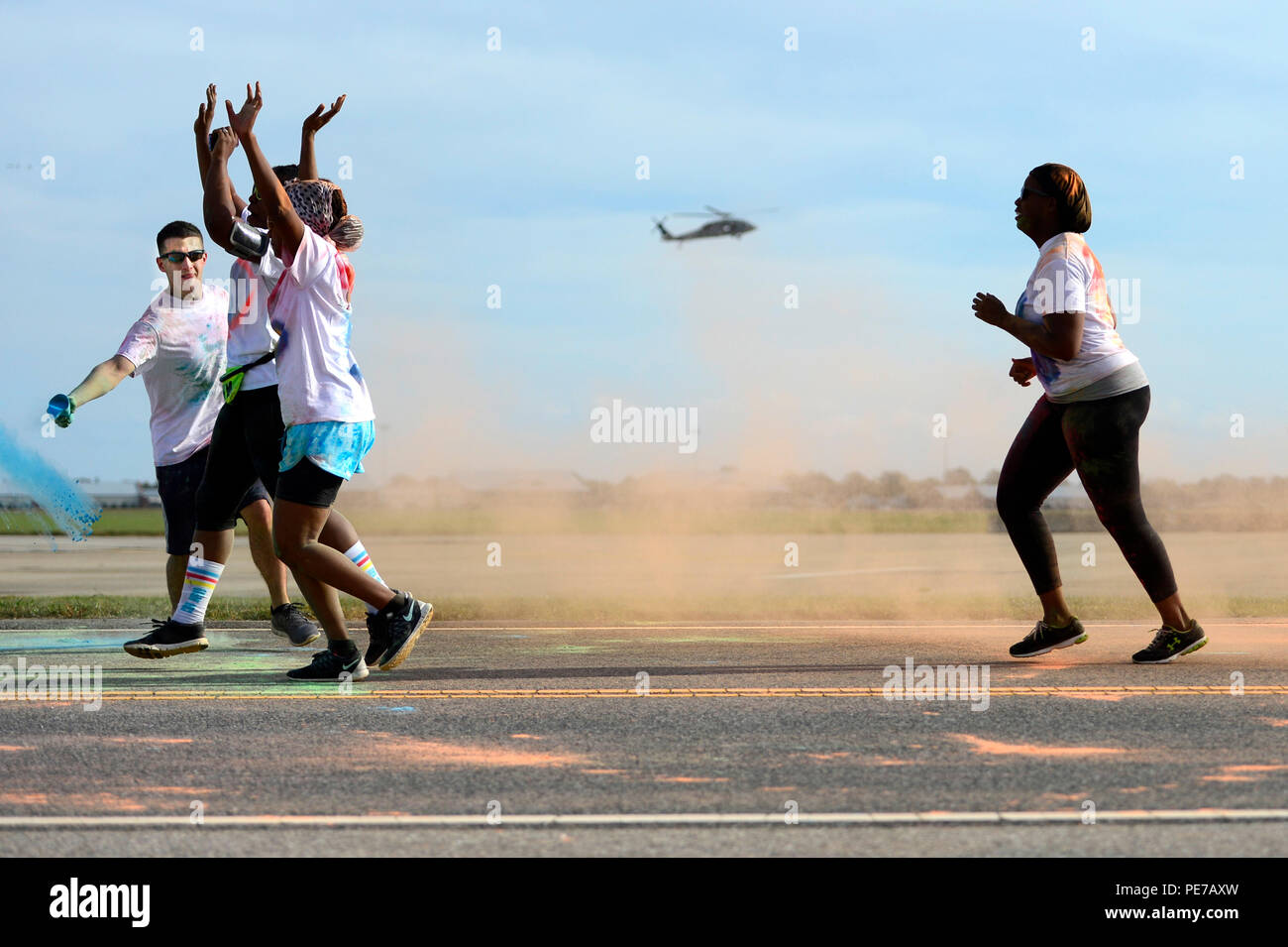 Runners pass through a color station during the Joint Base Langley ...
