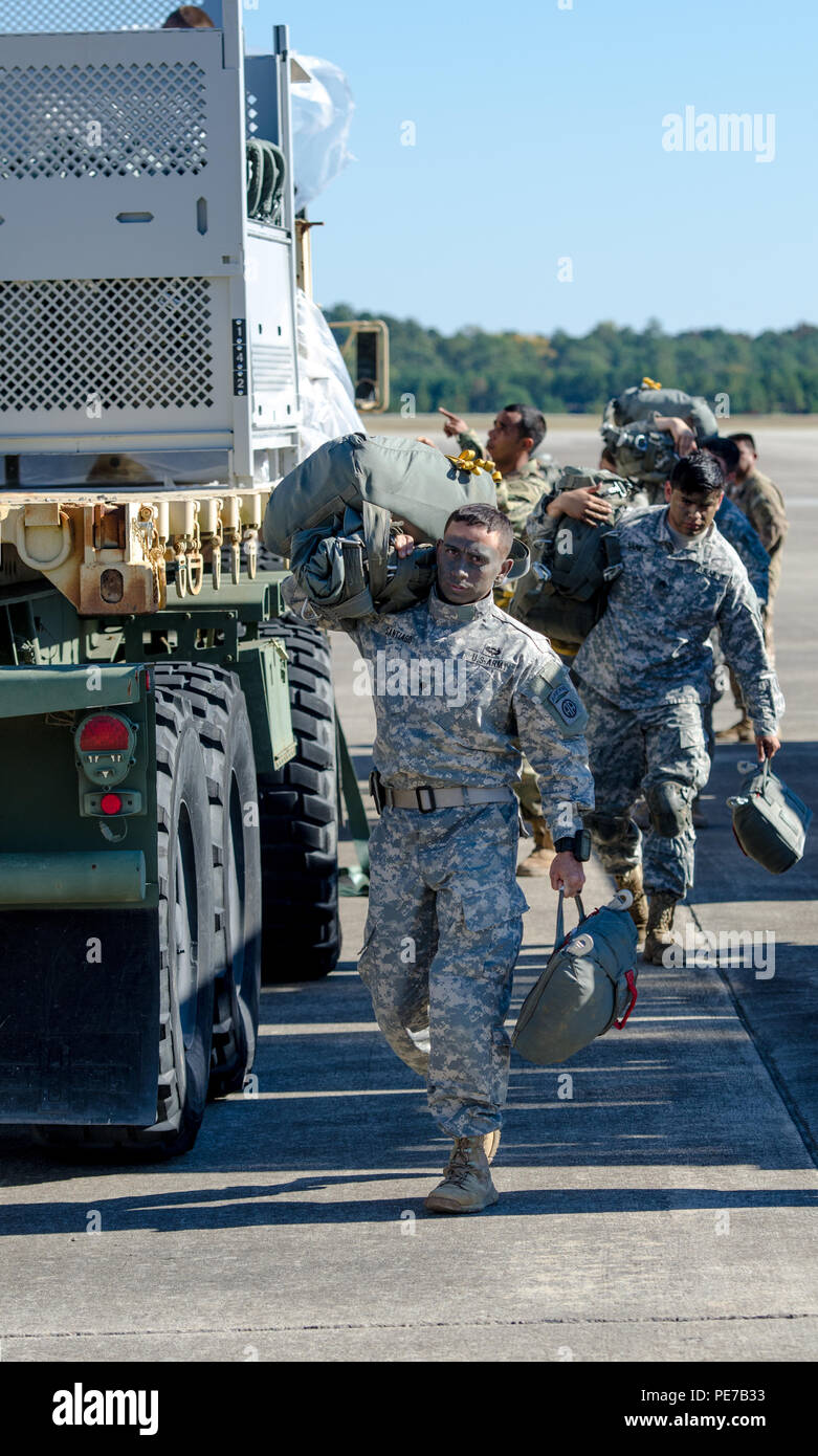 Paratroopers are issued their parachutes and weapons systems in ...