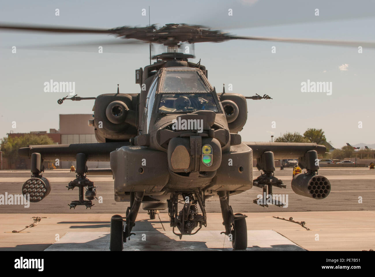 An Apache helicopter and its crew taxis across the flight line on its ...