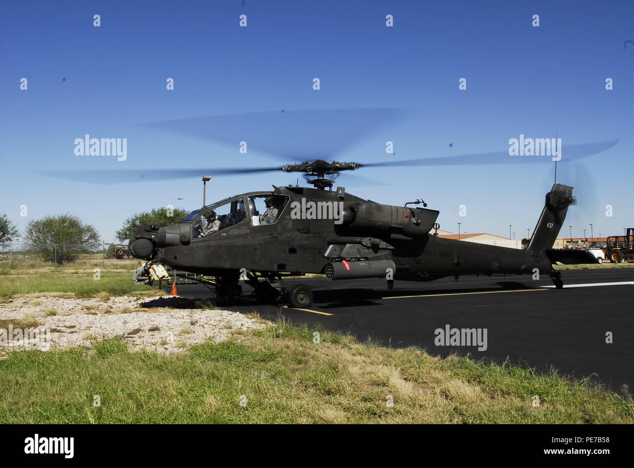 An Apache helicopter and its crew arm the Apache and prepare for ...