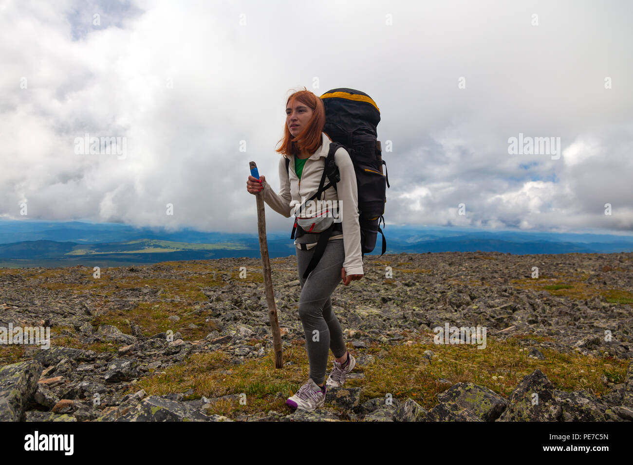Atmospheric moment in mountains. Hiking woman with backpack traveler on ...