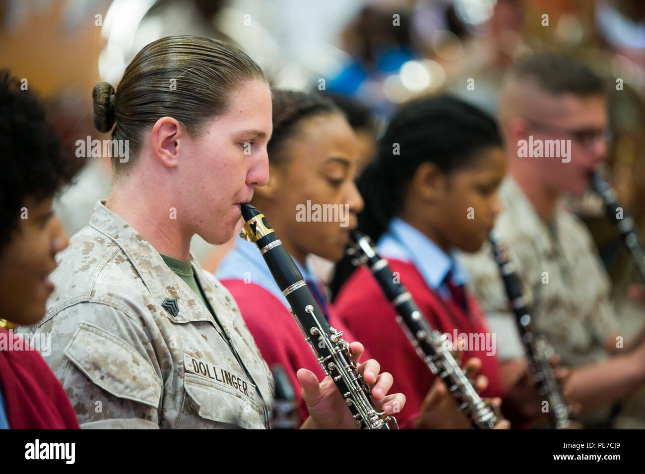 Sgt. Elizabeth Dollinger performs alongside students at the Cedar ...