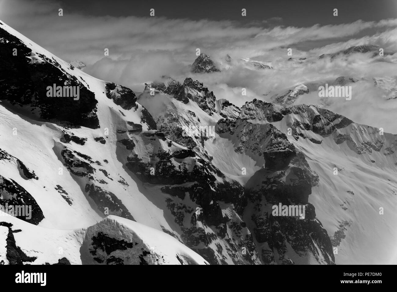 View at the mount Titlis peak in foggy misty weather in black and white ...