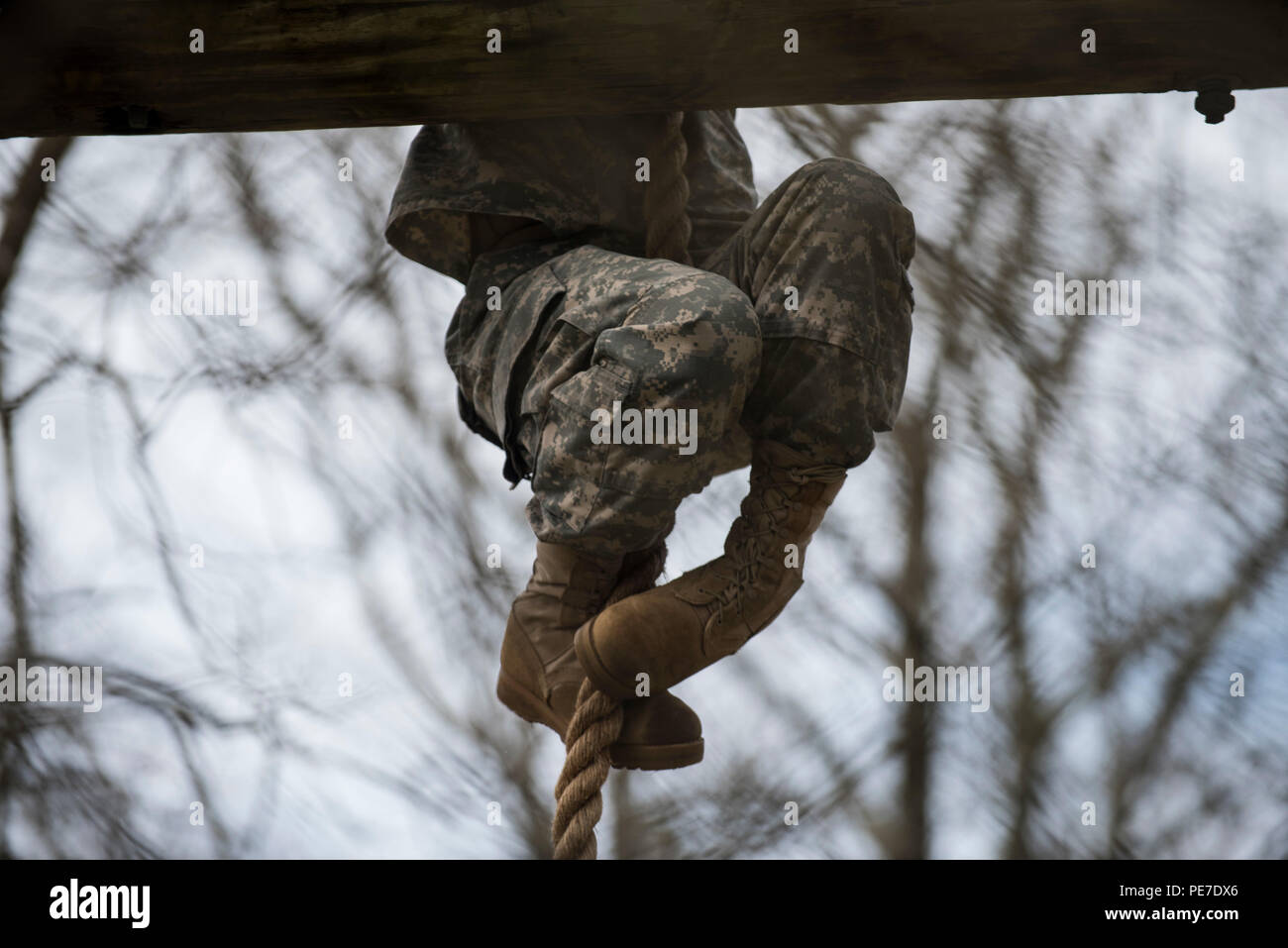A U.S. Army Reserve Soldier climbs a rope as part of a confidence ...