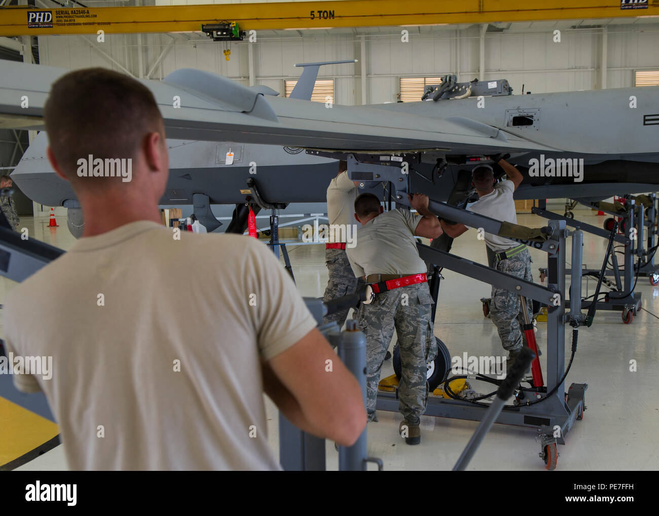 Airmen from the 49th Aircraft Maintenance Squadron affix the left wing ...