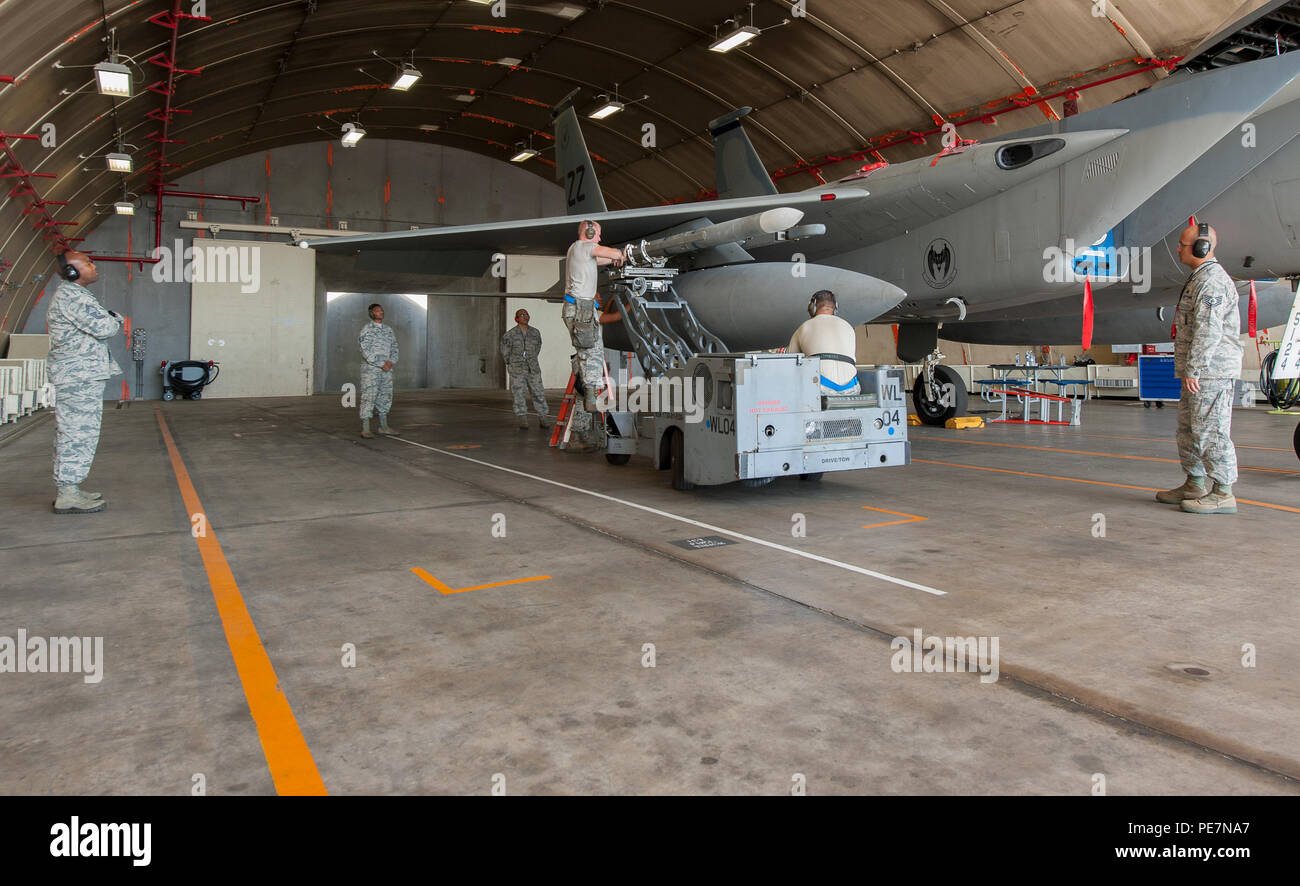 A weapons load crew team from the 44th Fighter Squadron works together ...