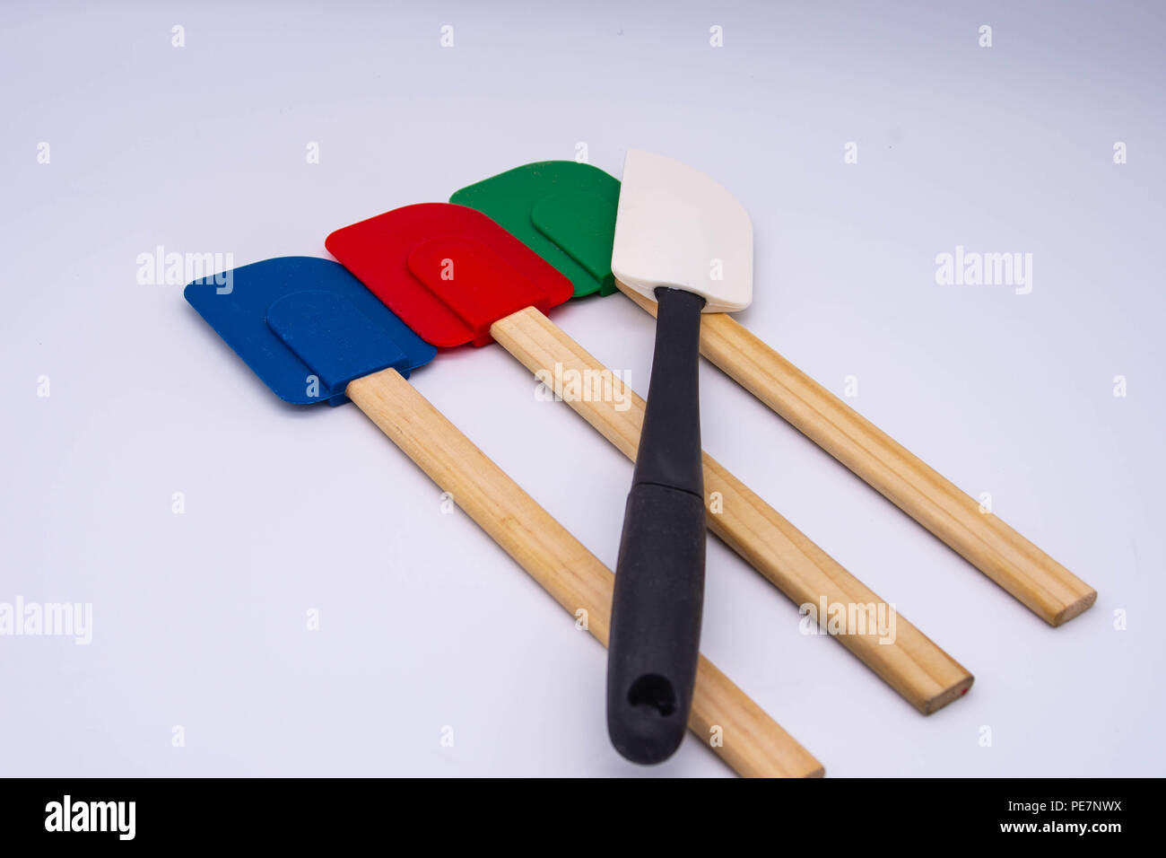 various colored spatulas with wood handle Stock Photo - Alamy