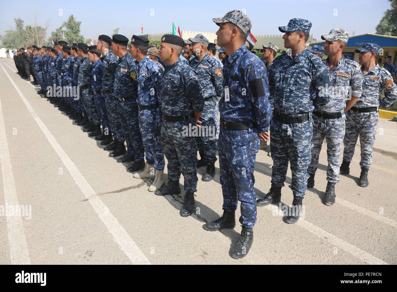 Iraqi federal police officers stand in formation during the 19th Iraqi ...
