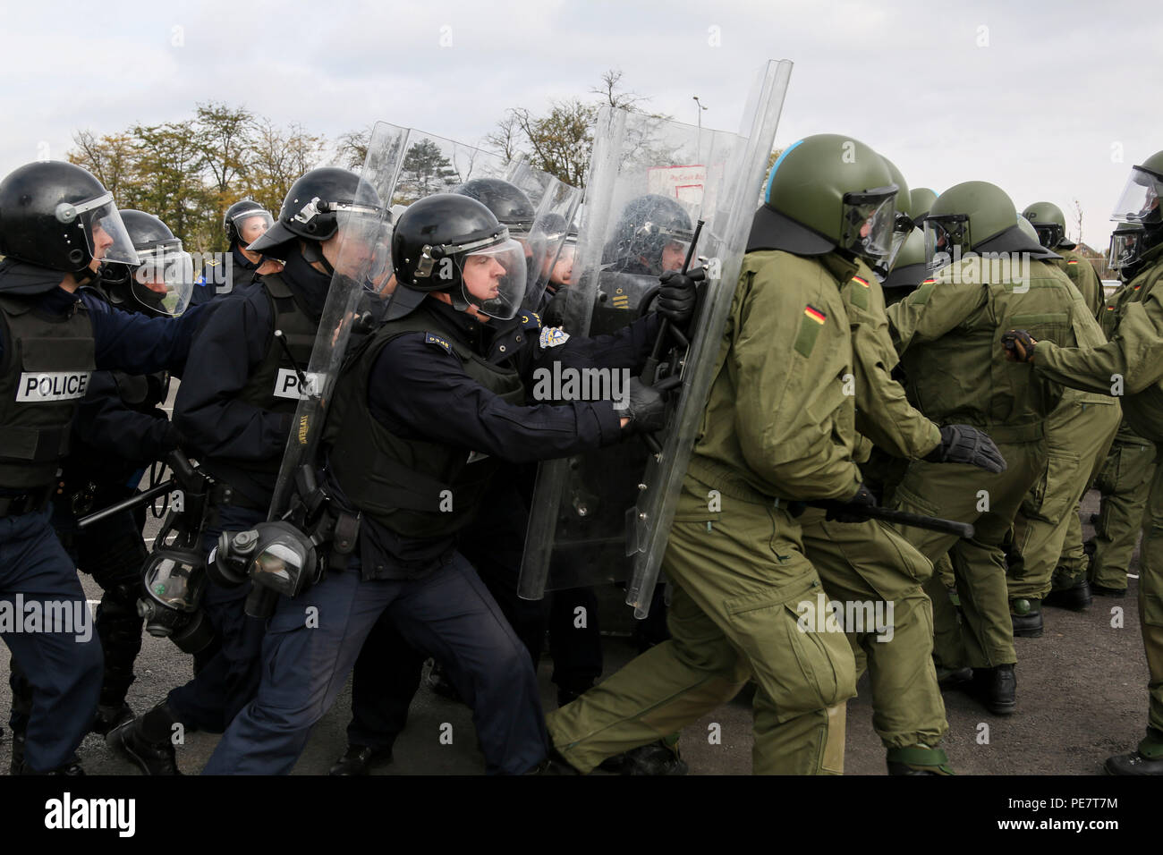 Kosovo Police push their riot shields against a group of German ...