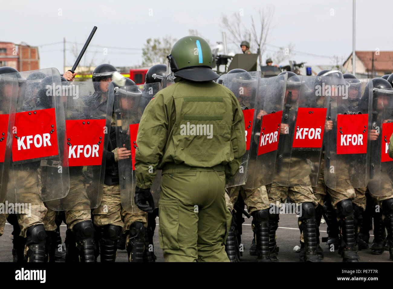 A German soldier, role playing as a protester, stands in front of a ...