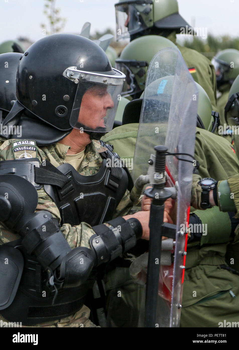 A Turkish soldier holds his riot shield against role-playing protesters ...