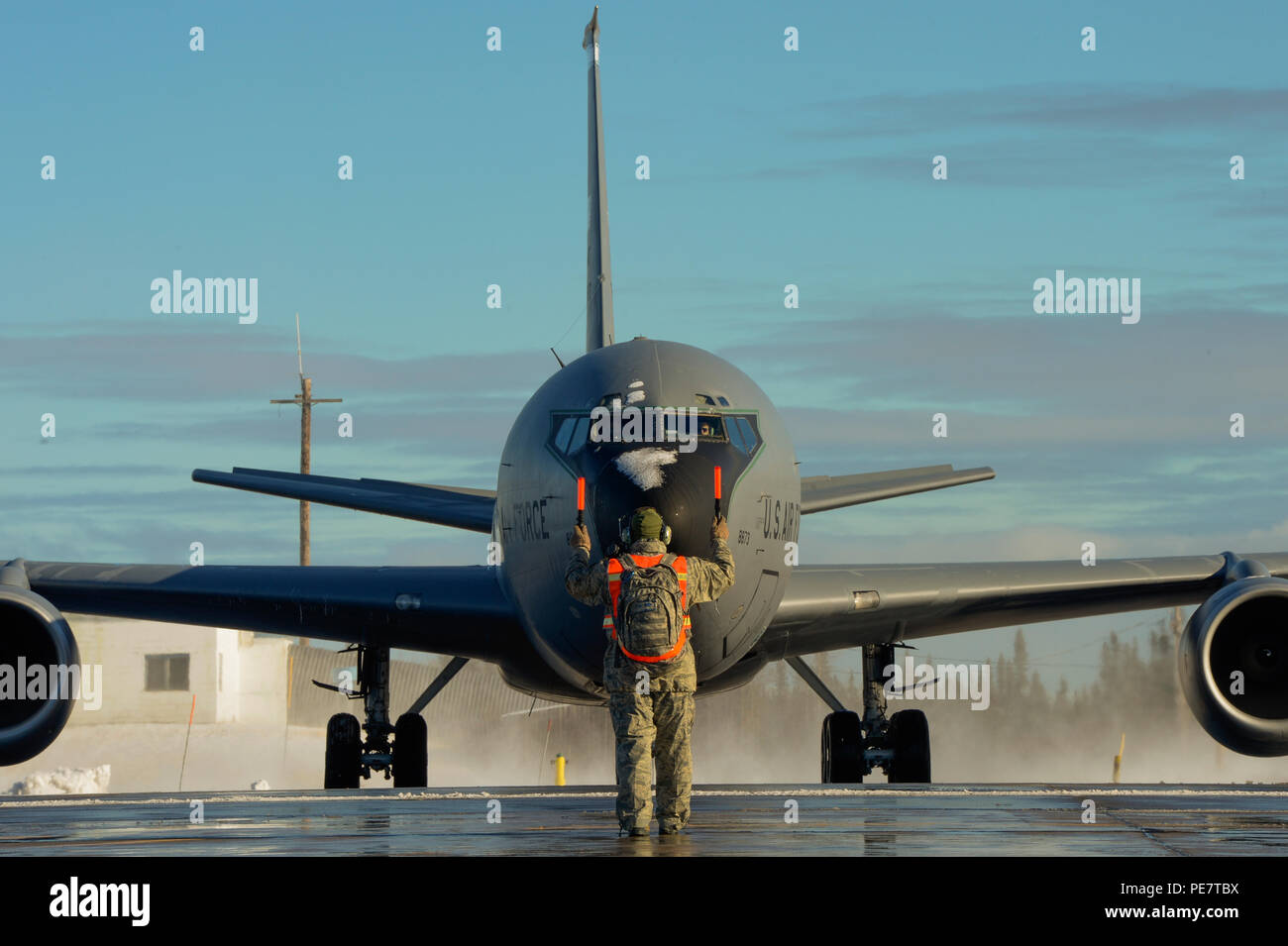 A U.S. Air Force crew chief marshals a KC-135 Stratotanker prior to a ...
