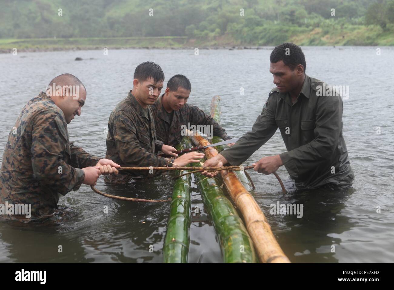 Marines learn how to build a raft made out of bamboo during a training ...