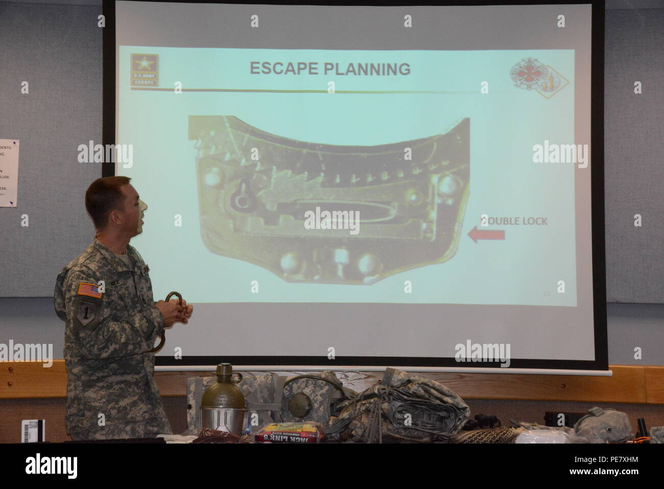 A U.S. Army Sergeant 1st Class demonstrates the internal mechanism of ...