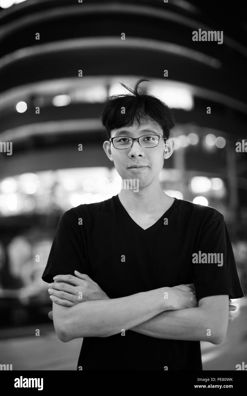 Black And White Portrait Of Asian Man Outdoors At Night Stock Photo - Alamy