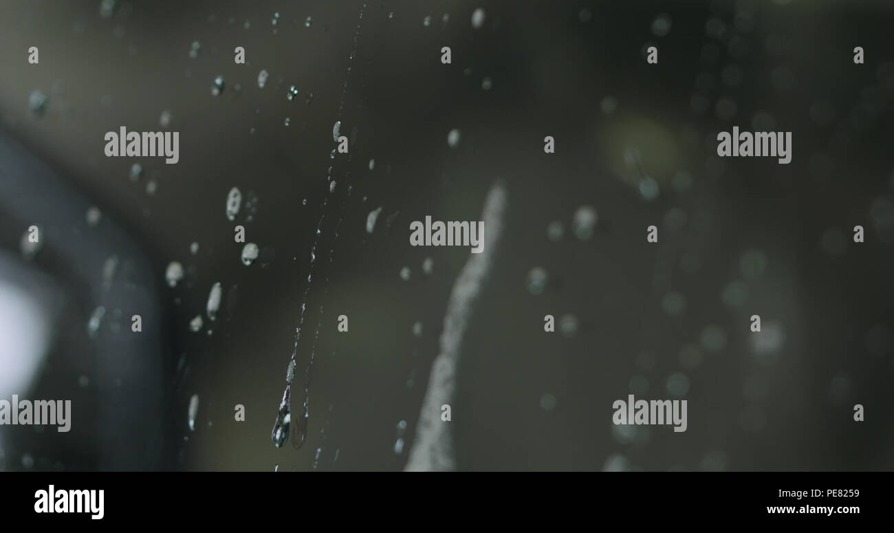 closeup water drop sliding down car side window, wide photo Stock Photo ...