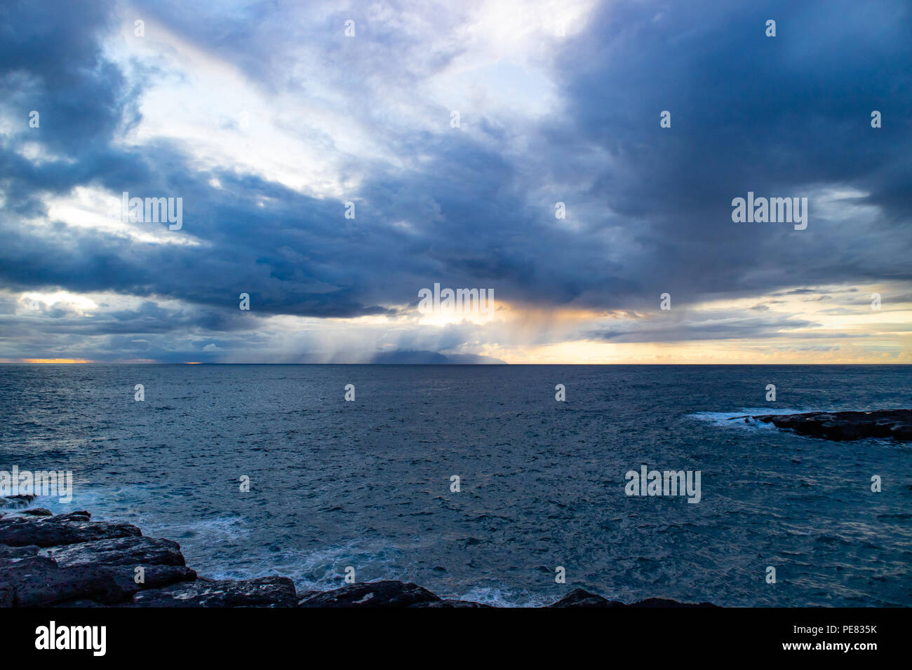 Seascape with rocky shore, atlantic ocean water, dramatic clouds with ...