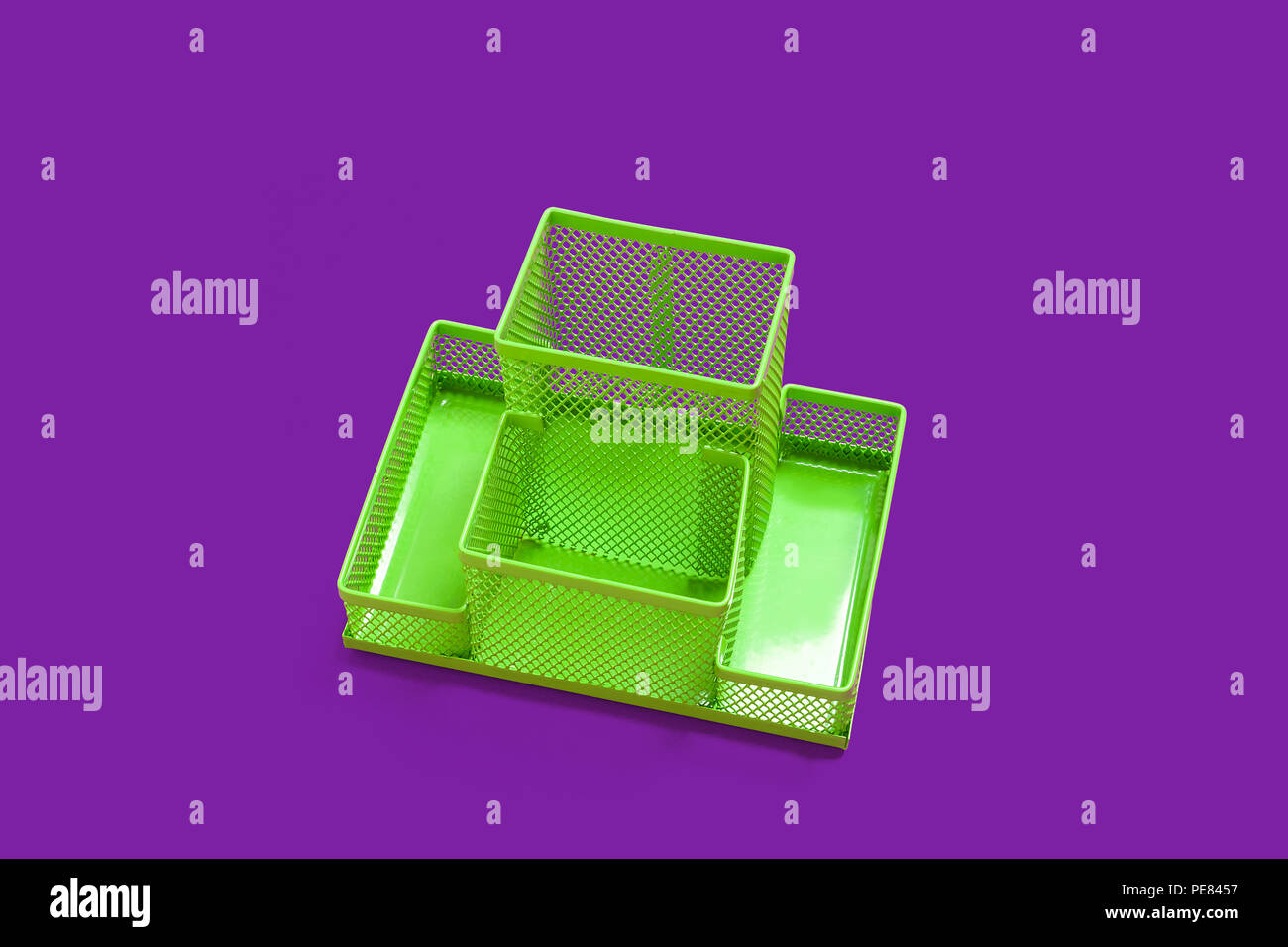 green empty pencil holder on a purple surface Stock Photo - Alamy