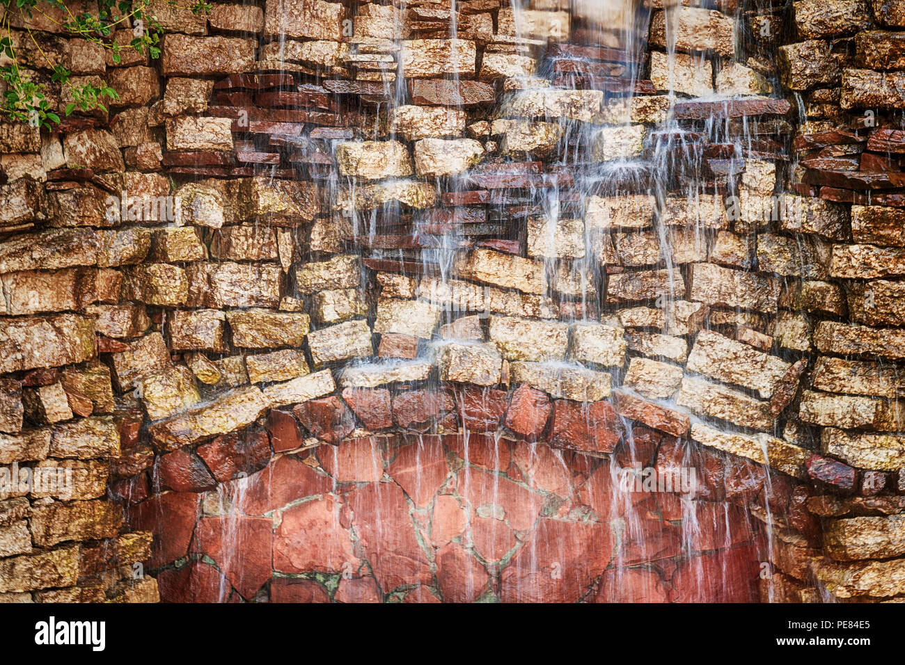Decorative waterfall. Rough stone wall and streaming water Stock Photo ...