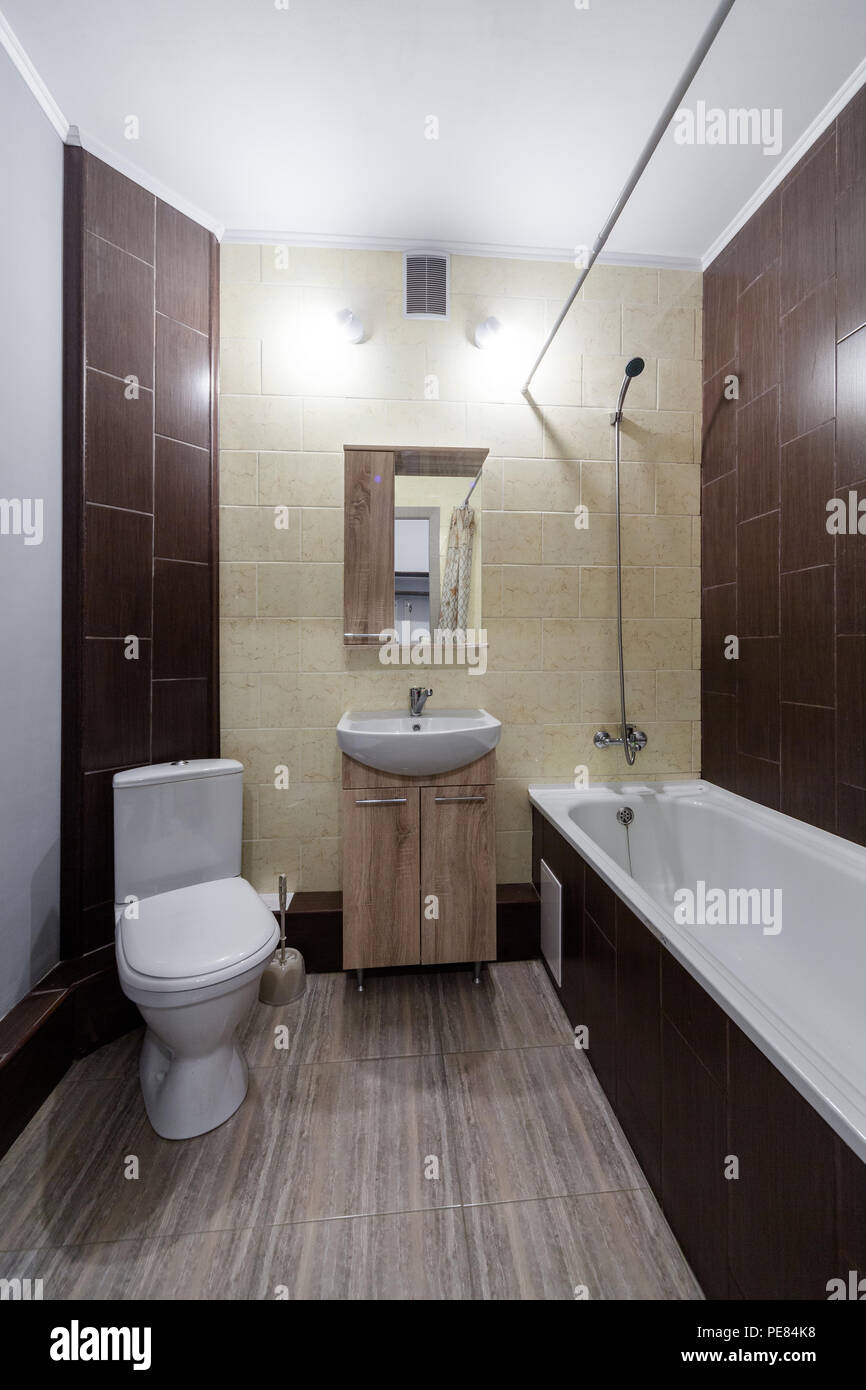 Modern wooden small restroom with little sink Stock Photo - Alamy